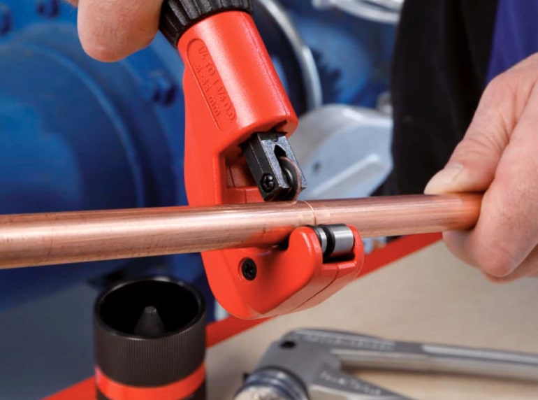 using a tool on copper pipe